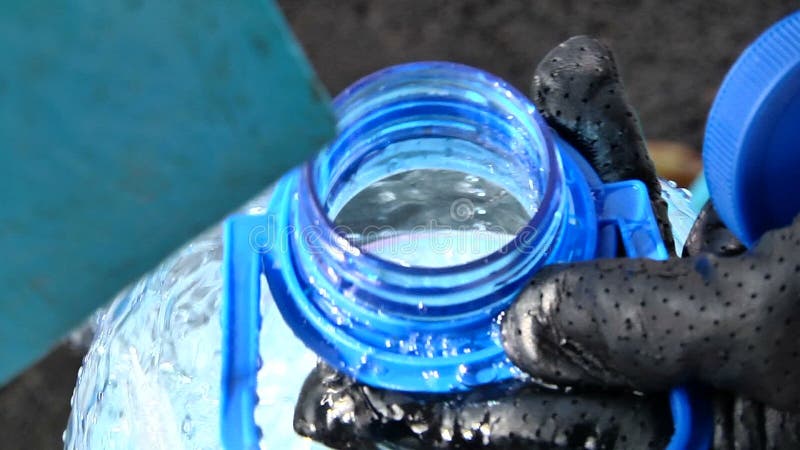The Girl Pours Drinking Water from Hydrant in a Plastic Bottle Stock ...