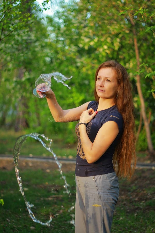 The Girl Pours Water from a Glass Stock Photo - Image of dress, model ...