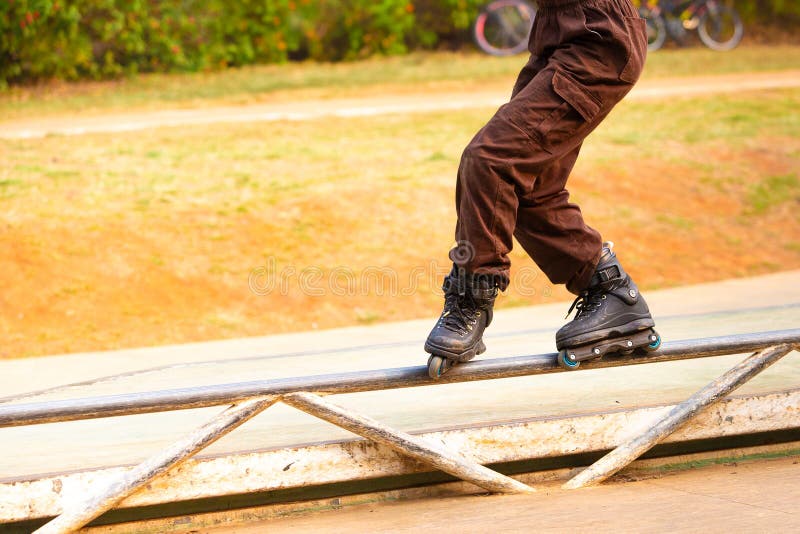 Girl Practicing the Soul Grind Maneuver on the Railing on Roller Skates ...