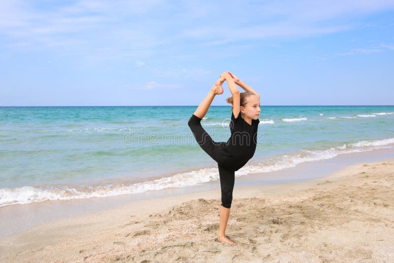 Girls Practicing Yoga on Beach. Children are Sitting in Lotus Position ...