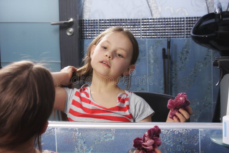Girl preening at mirror stock photo. Image of child, hair - 13887168