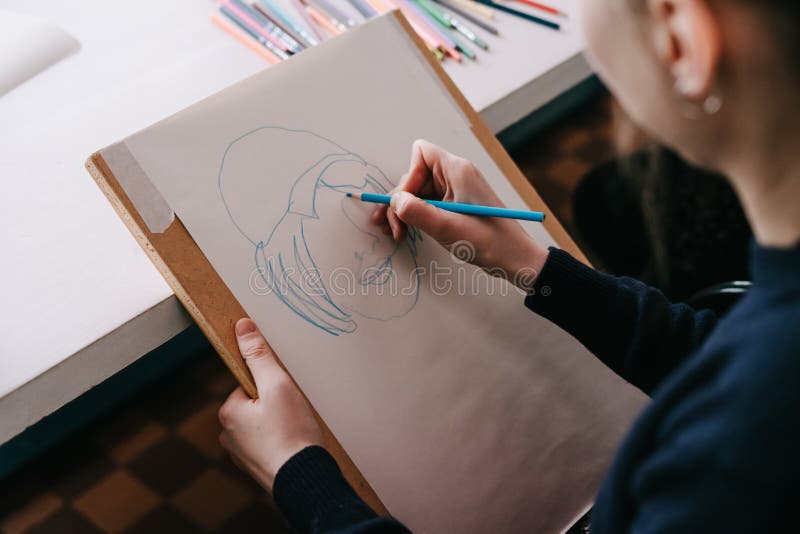 The Girl is in the Process of Drawing. Sketching with a Colored Pencil ...