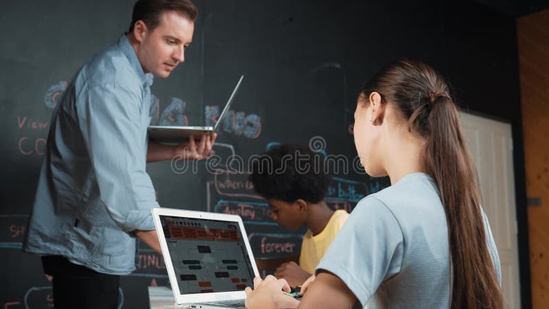 Girl Programming or Coding System while African Boy Fixing Model ...