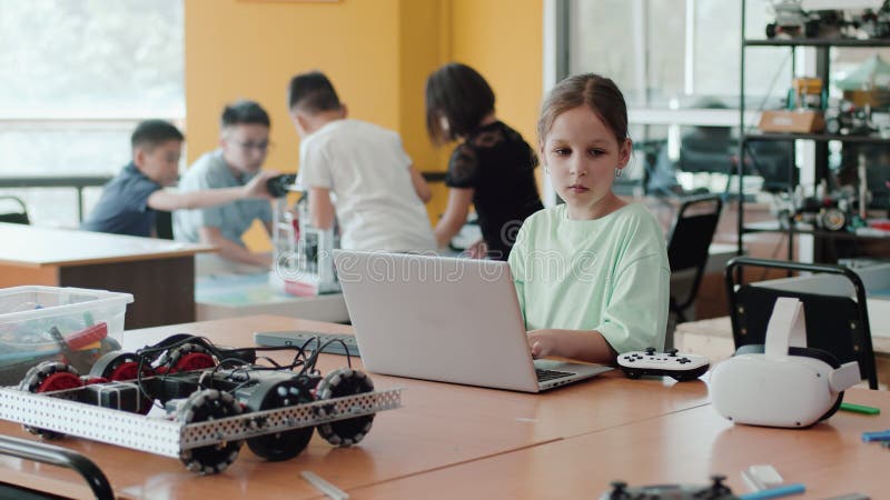 Children in a Class at a Robotics Lesson Watch How the Robot Moves after Its Successful ...