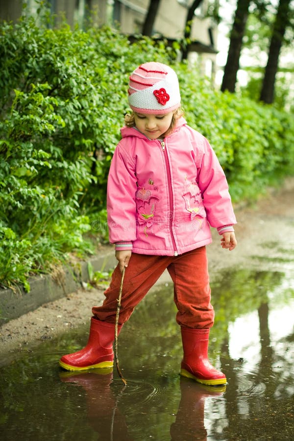 Girl in the puddle stock image. Image of rainboots, baby - 12868041