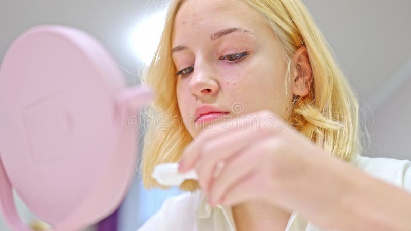 Teenage Girl Blonde Puts on Contact Lenses in Front of a Mirror. Stock ...