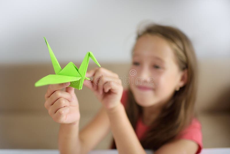The Girl Puts Origami from Paper. Stock Image - Image of class ...