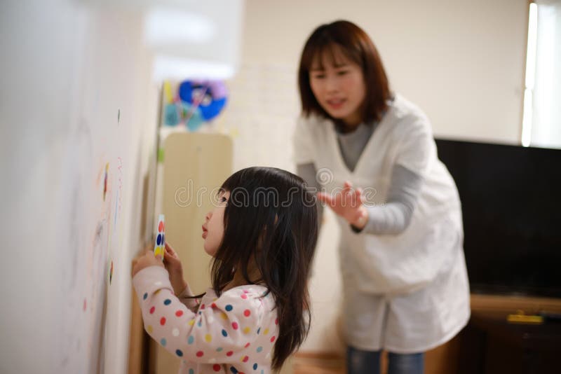 Girl Putting a Sticker on the Wall Stock Photo - Image of living ...