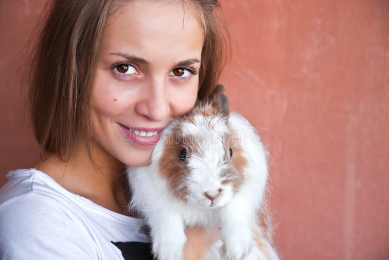 Girl with a rabbit. stock image. Image of indoors, cheerful - 25453085