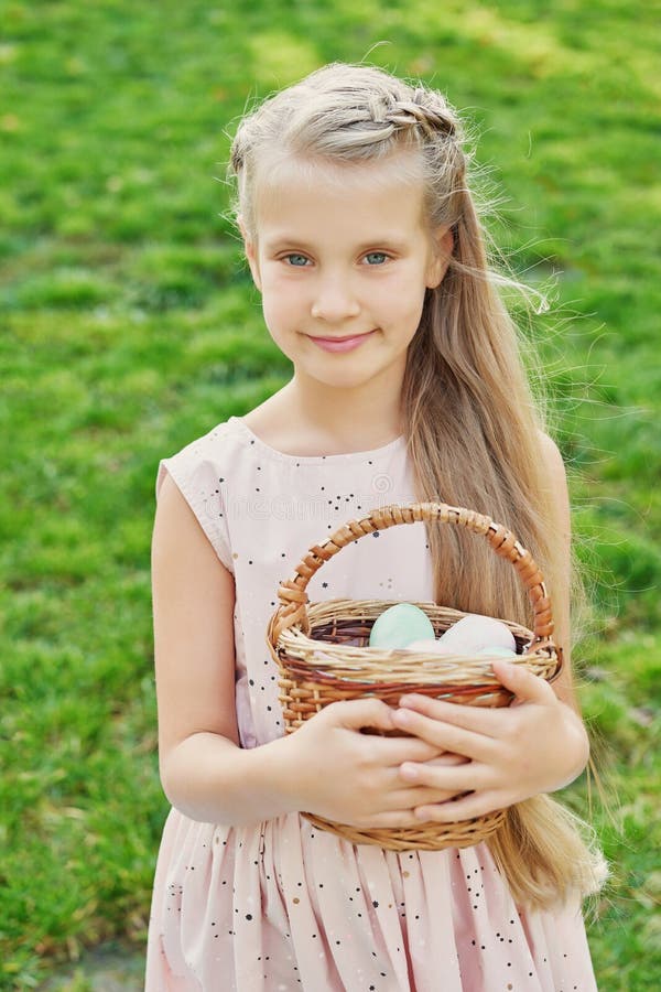 Girl with Rabbit and Eggs for Easter in the Park on Green Grass Stock ...