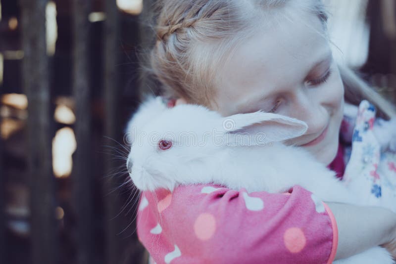 Girl and rabbit stock photo. Image of meadow, happy - 176843742