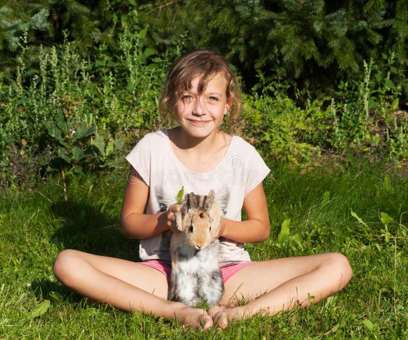 Girl with Rabbit Sitting on the Meadow Stock Photo - Image of green ...