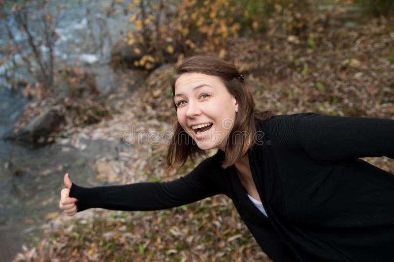 Girl with a Raised Thumb on the River Stock Image - Image of brown ...