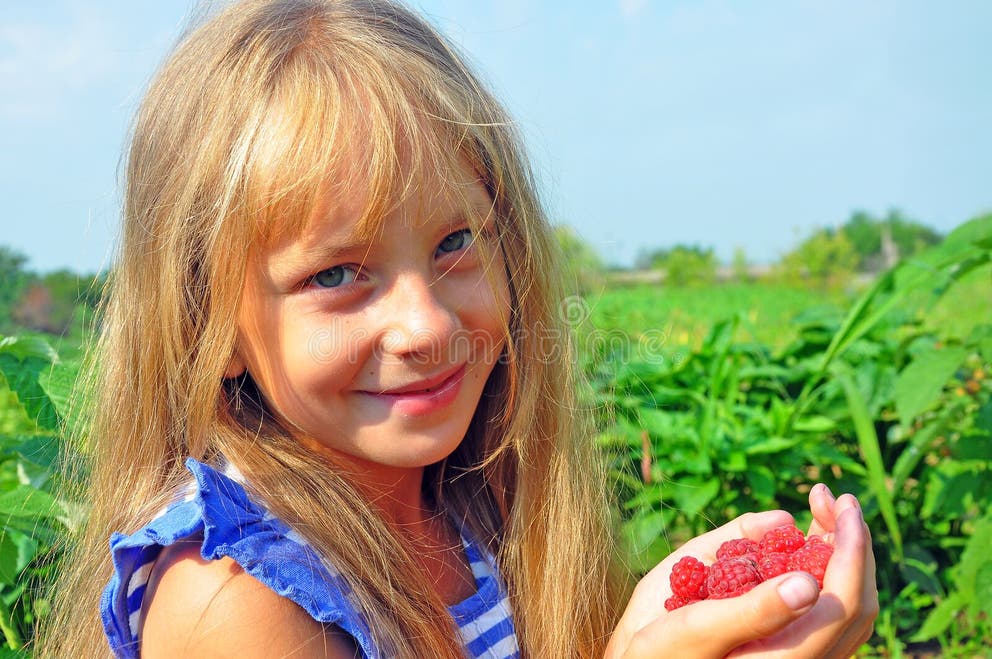 Girl with raspberries stock photo. Image of blond, smile - 20636748
