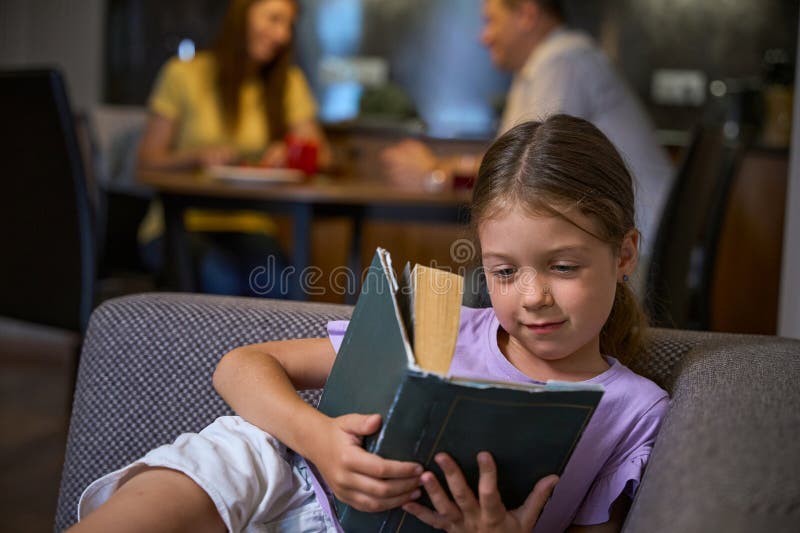 Girl is Reading a Book on a Cozy Sofa Stock Photo - Image of hotel ...
