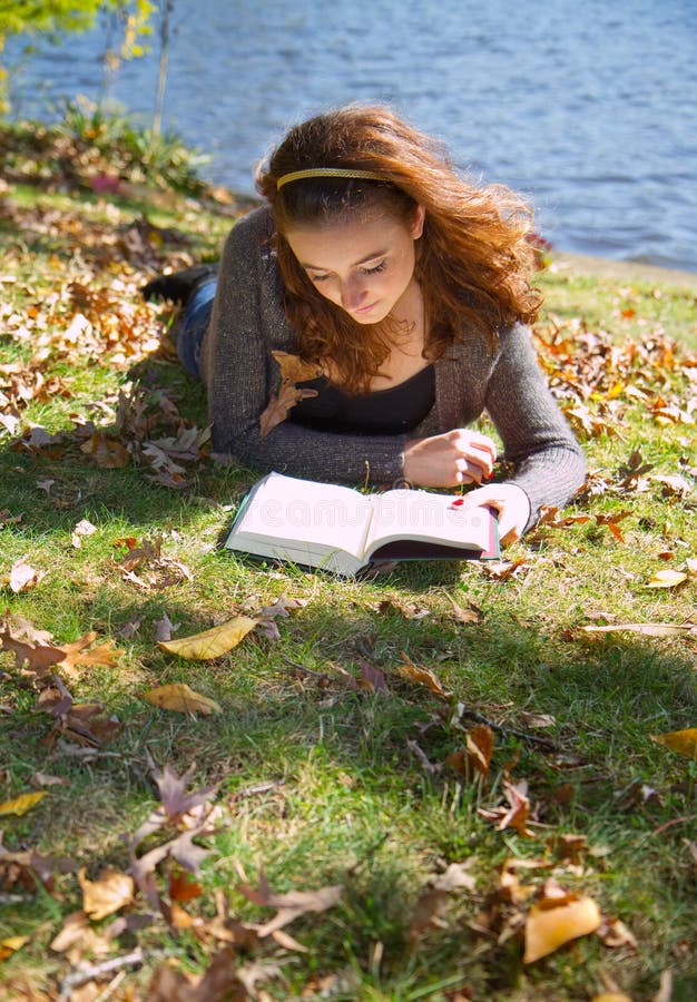 Girl Reading Book among Fall Leaves Stock Image - Image of learning ...