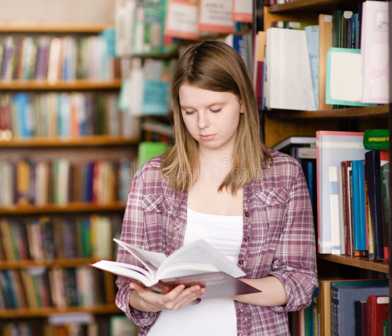 Girl Reading a Book at the Library Stock Image - Image of caucasian ...