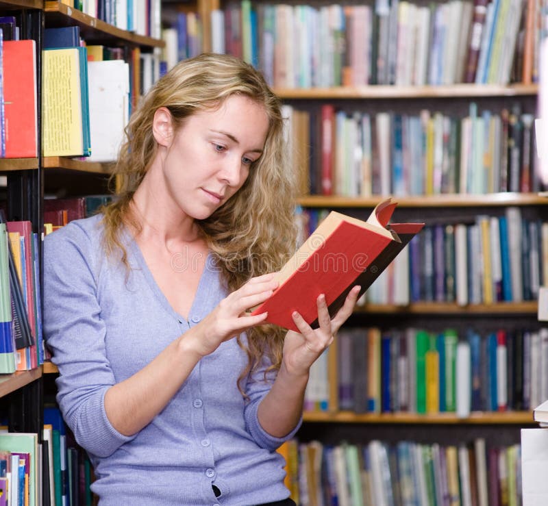 Girl Reading a Book at the Library Stock Photo - Image of education ...