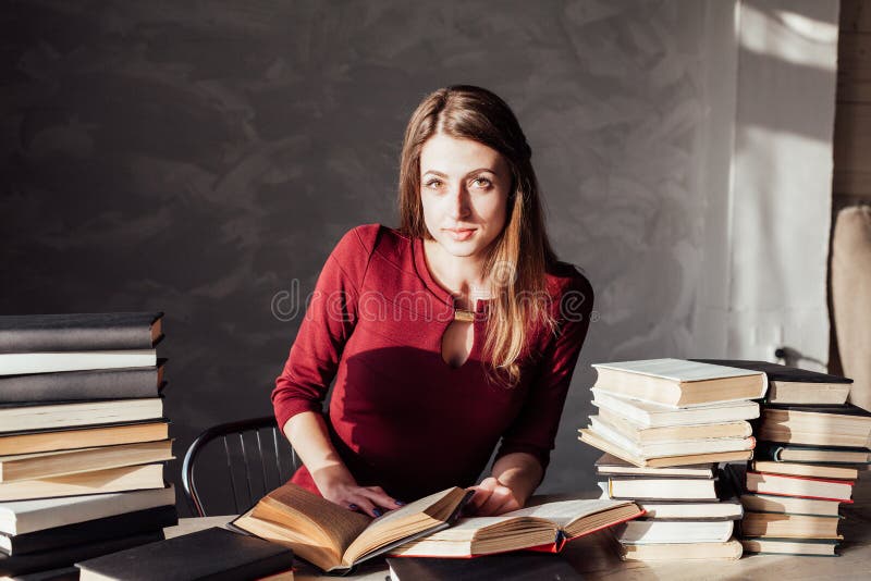 Girl Reading a Book in the Library is Preparing for the Exam Stock ...