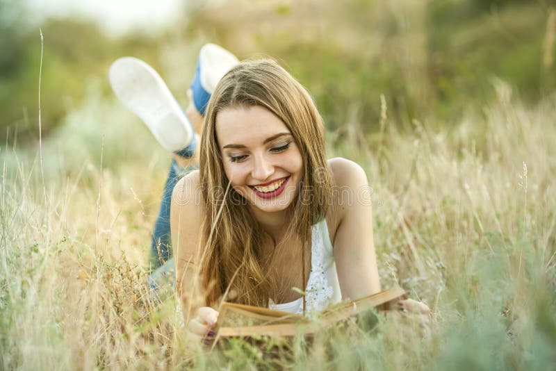 A Girl Reading a Book Outside Stock Photo - Image of park, student ...