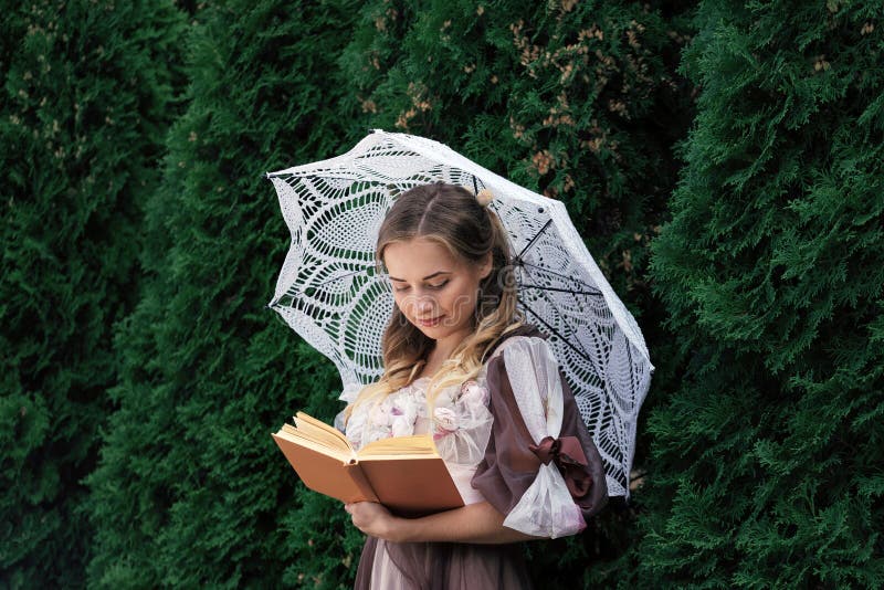 Girl Reading Book Standing Under Umbrella Stock Photos - Free & Royalty ...