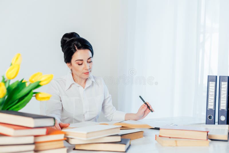 Girl Reading Book at the Table in the Office Business Stock Photo ...