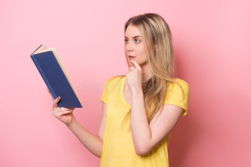 Girl Reading a Book and Thinking Near Pink Wall Stock Photo - Image of ...