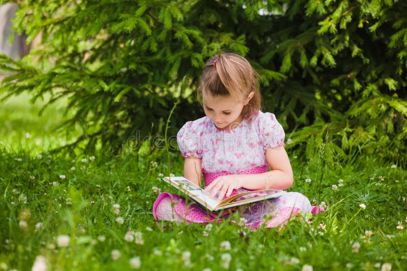 Girl is Reading on the Grass Stock Image - Image of grass, nature: 51874093