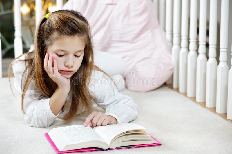 Girl reading homework stock image. Image of cushion, young - 19720479