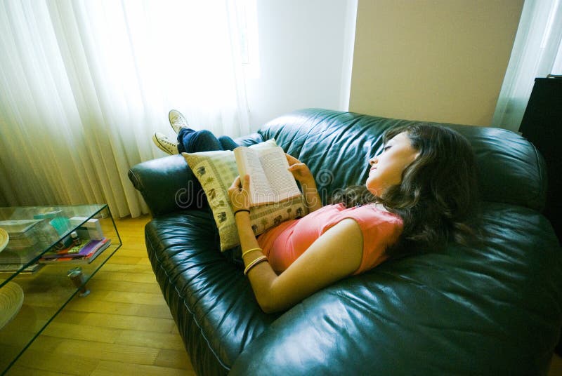 Girl reading on sofa stock image. Image of studying, reading - 2714835