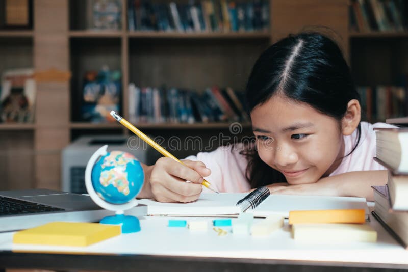 Girl Reading and Writing and Do Homework in Library Stock Photo - Image ...