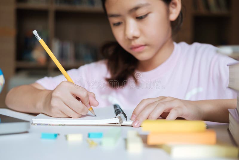 Girl Reading and Writing in Library of School. Stock Photo - Image of ...