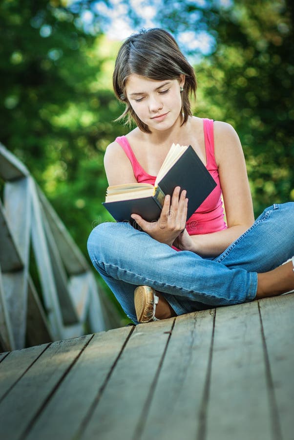 Girl reads book stock image. Image of outdoors, caucasian - 69221125