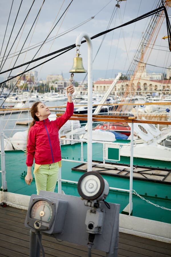 Girl in Red Jacket Clangs Bell on Ship Stock Image - Image of bell ...
