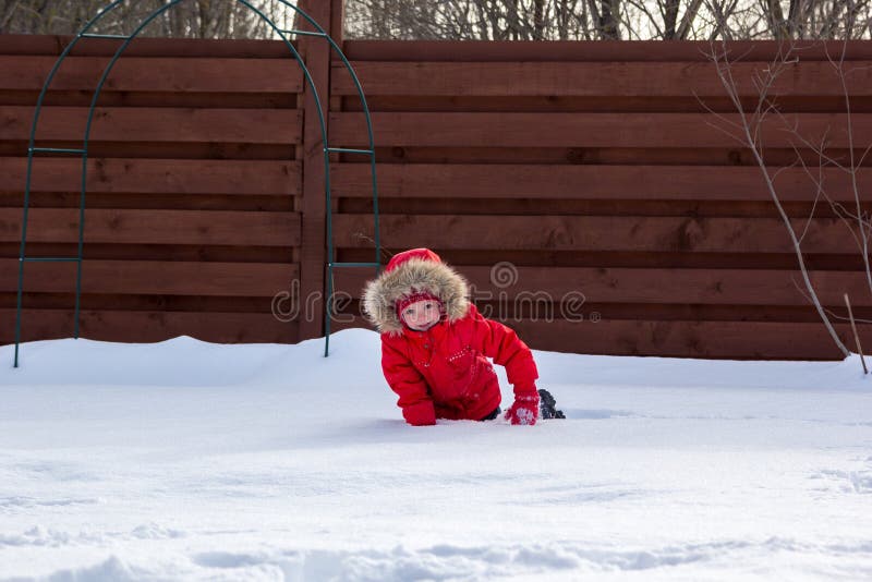 Girl in Red Jacket Creeps through the Snow Stock Image - Image of ...