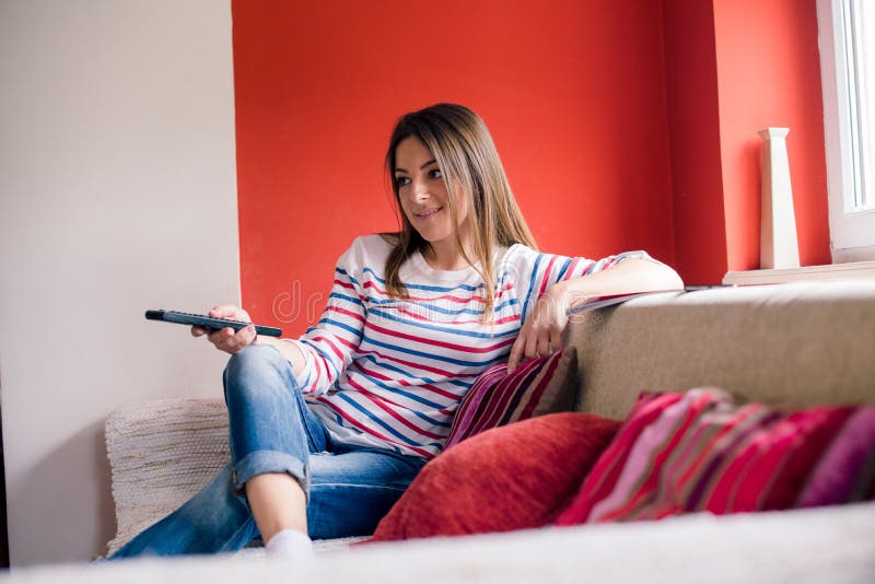 Girl with Remote Control on Sofa Stock Photo - Image of domestic, girl ...