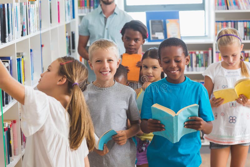 Girl Removing Book from Bookshelf in Library Stock Image - Image of ...