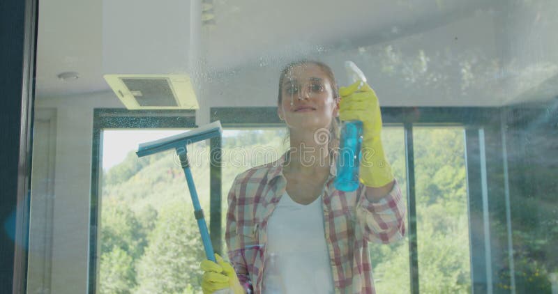 Girl Removing Cleaning Solution from Glass with Special Tool, Cleaning ...