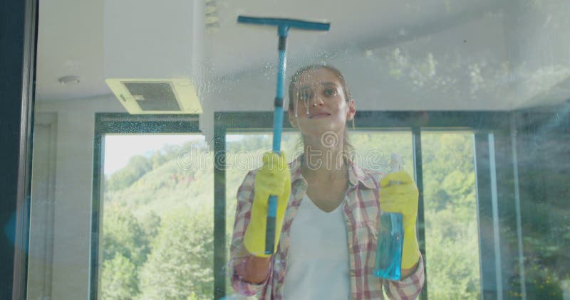 Girl Removing Cleaning Solution from Glass with Special Tool, Cleaning ...