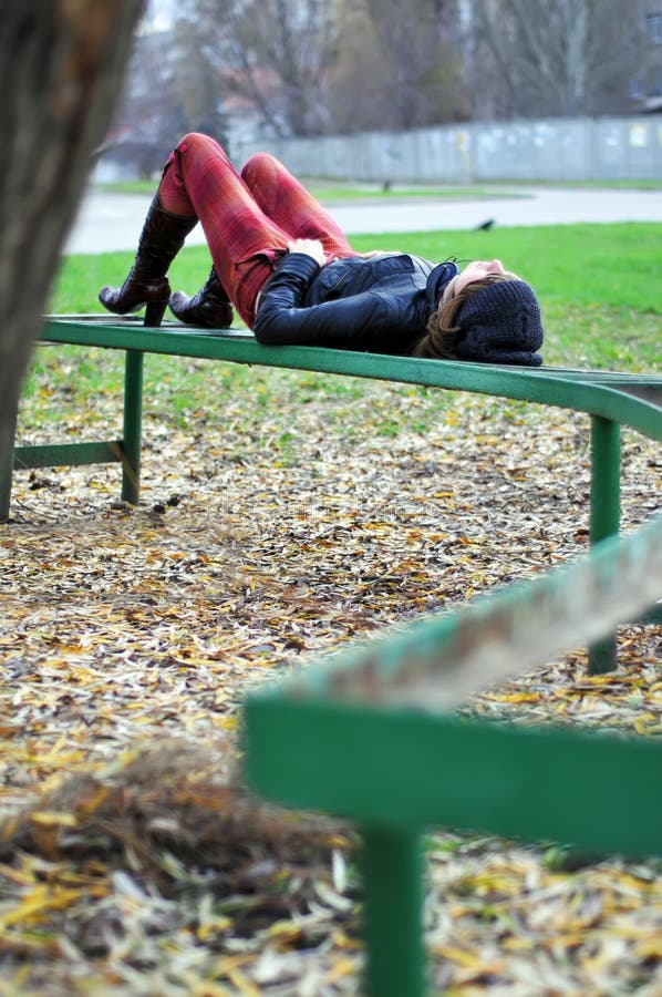 Girl resting on a bench stock image. Image of autumn - 16702287