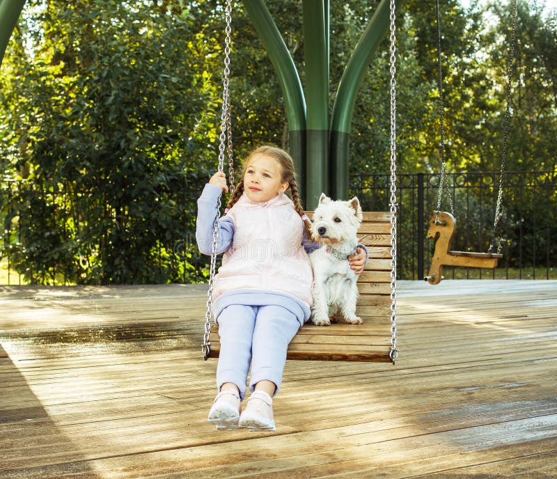 Girl Ride on a Swing with a White Dog Stock Photo - Image of love, girl ...