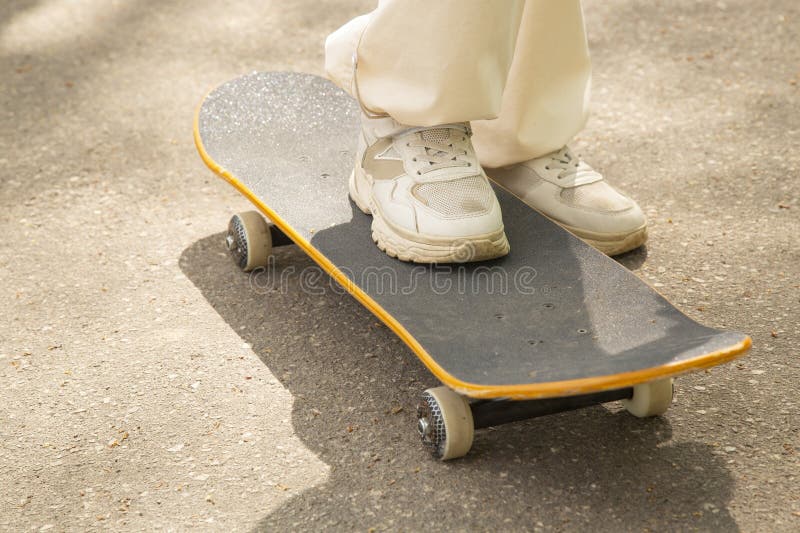A Girl Rides a Skateboard in a City Park in the Spring Stock Photo ...