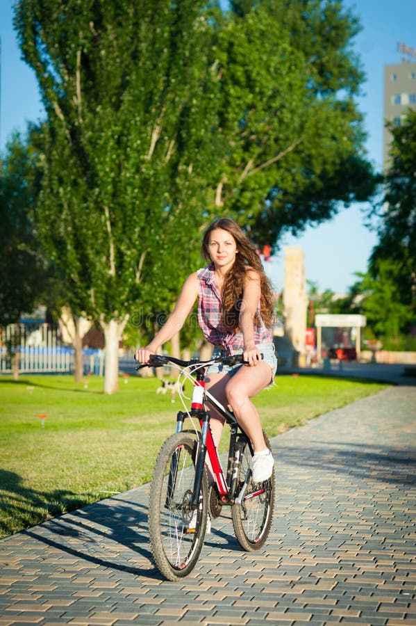 Girl riding on bicycle stock image. Image of exercise - 55349655