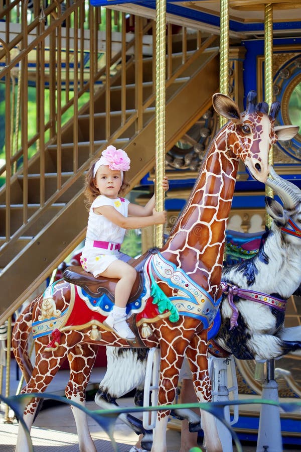Girl riding on a carousel stock image. Image of circle - 18608997