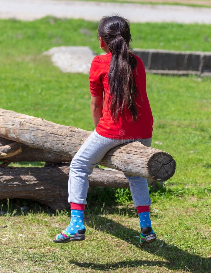 Girl Riding a Log in the Park Editorial Image - Image of park, nature ...
