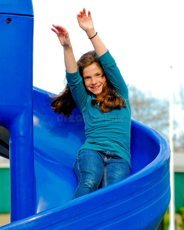 Girl riding a slide. stock image. Image of jeans, excitement - 28096491