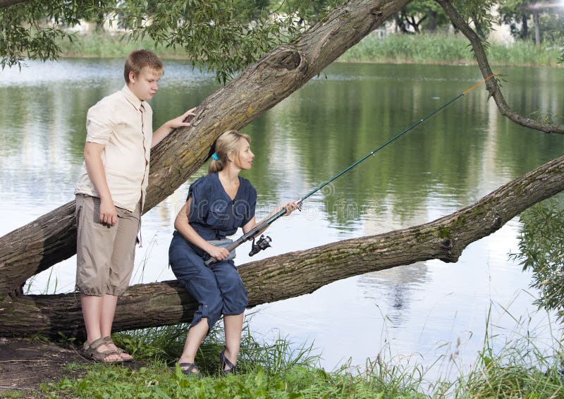 The Girl with a Rod and the Guy Looks at it Stock Photo - Image of ...