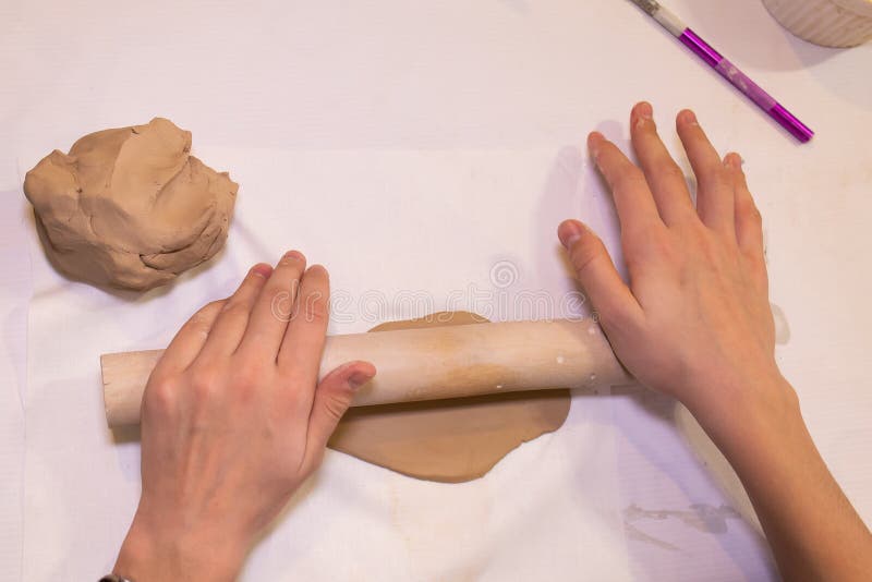Girl Rolls the Clay in the Studio Stock Image - Image of sculpt, dirty ...