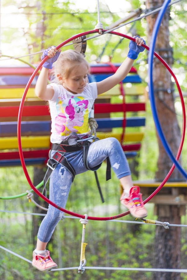 Girl in the Rope Park Pass Obstacles, Girl Climb the Road. Stock Image ...