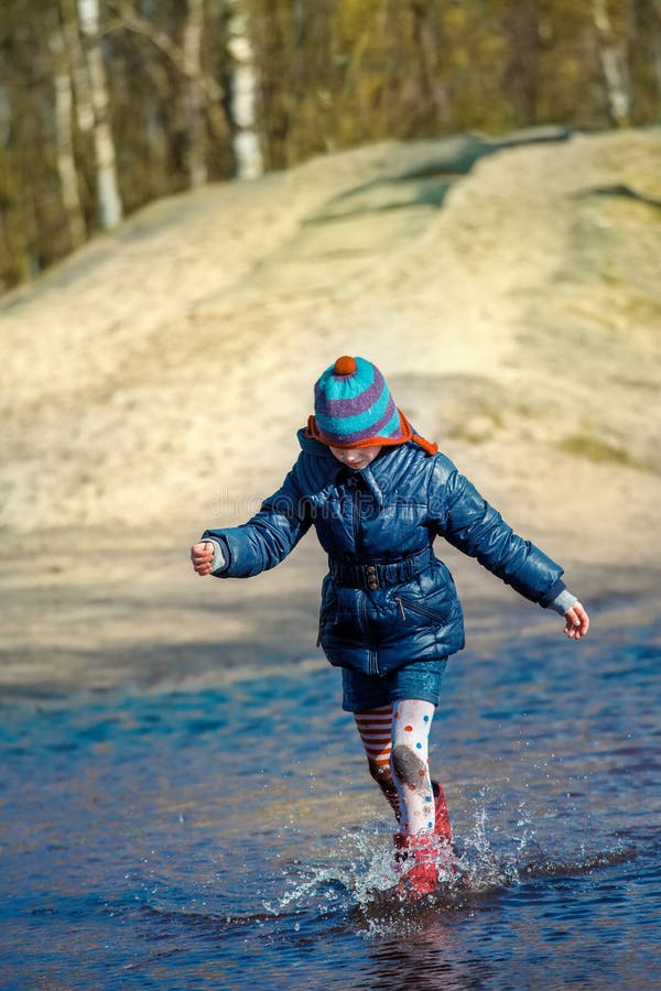 Girl Running and Jumping in Puddle Stock Image - Image of caucasian ...